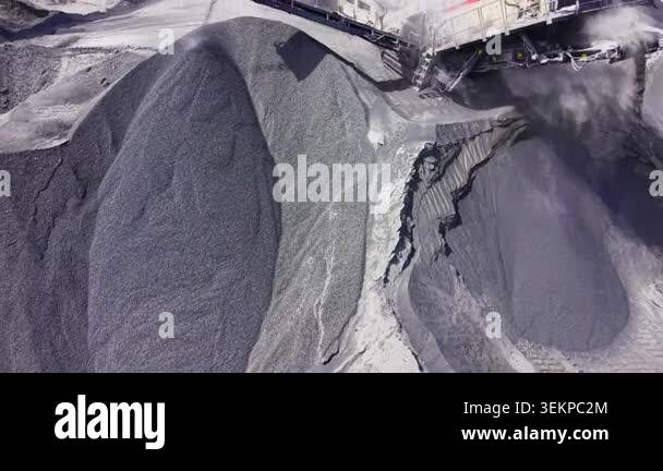 High angle view of mechanical arm discharging crushed stone onto a ...