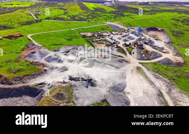 Aerial wide angle view of crushing machinery, aggregate stockpiles ...