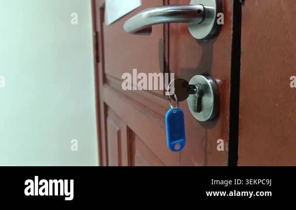 Footage of a metal key with a blue plastic key chain tag still stuck in ...