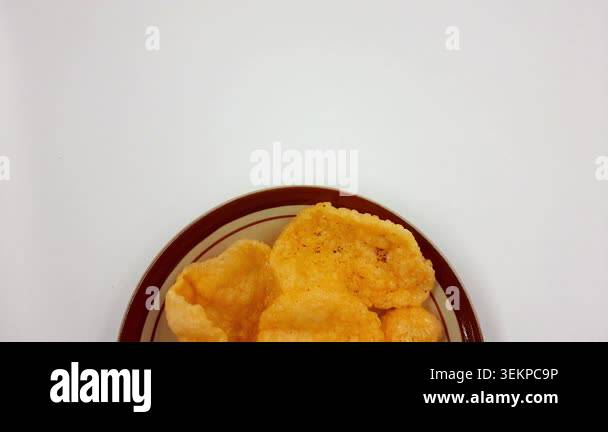 Cinematic top view motion footage of crispy fried crackers being served ...