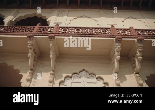Slow descending view of a historic Indian palace facade showcasing ...