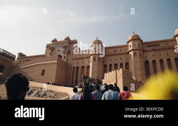Large crowd of local and foreign tourists walking up the steep path to ...