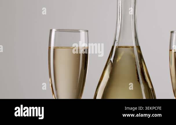 Golden champagne bubbles rising in elegant glasses next to a bottle of ...