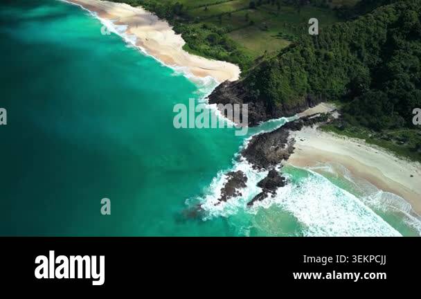 Aerial drone panning shot over Selong Belanak and Pantai Tomang-Omang ...