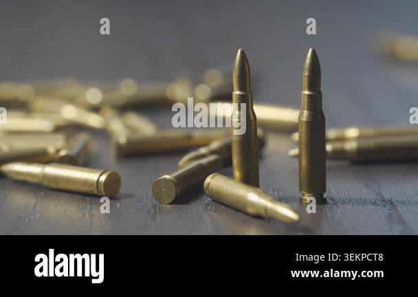 Many bullets on a wooden table. Concept of military, weapons and ...