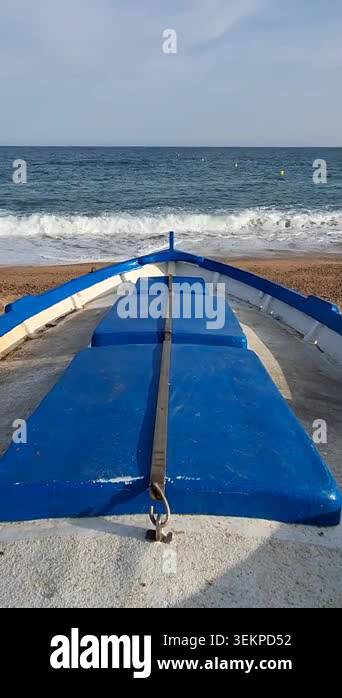 Fishing boats on the sandy beach with blue sky and sturm clouds Stock ...