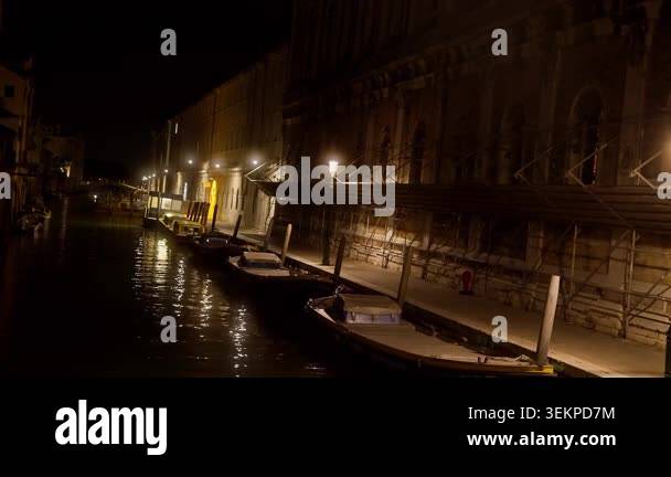 Peaceful Venice canal at night surrounded by historic architecture and ...