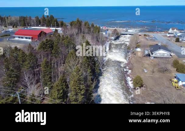 Scenic aerial video of floodwaters moving through Saint-Ulric-de-Matane ...
