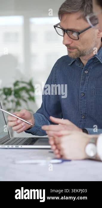 Architectural professionals reviewing blueprints on a desk with a ...