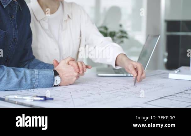 Architects collaborating on an innovative building project, designing a ...