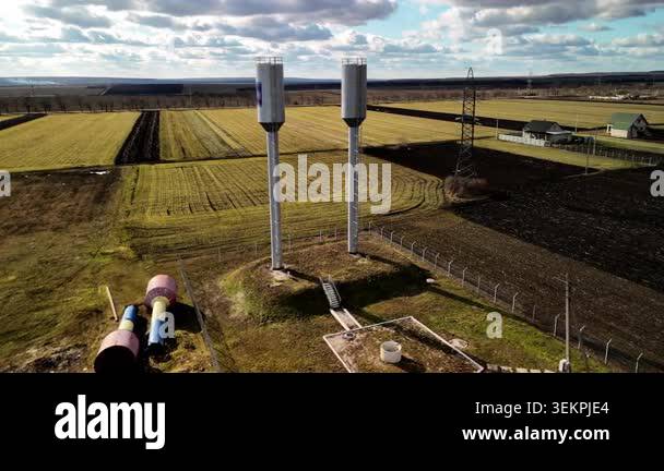 Water towers dominate the rural landscape, with expansive fields and ...