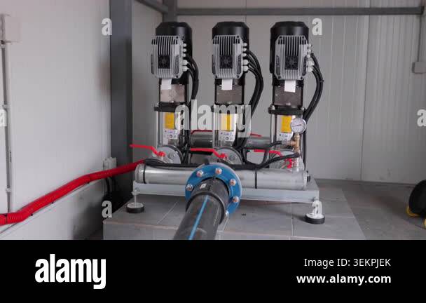 Industrial water pump system features three electric motors connected ...