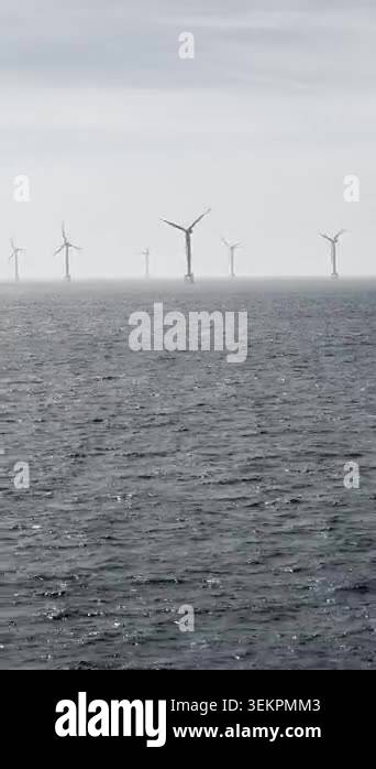 Vertical Offshore Wind Farm Video With Wind Turbines on the Sea Horizon ...