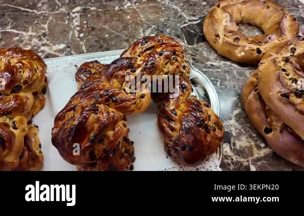 Traditional sweet buns and rolls with syrup on a display table. Golden ...