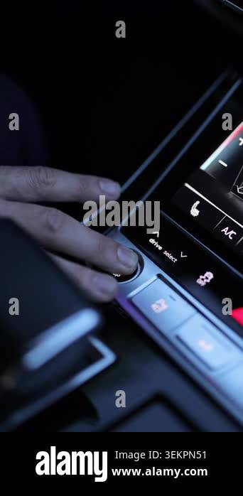 Vertical video of finger press the button to start the car engine ...