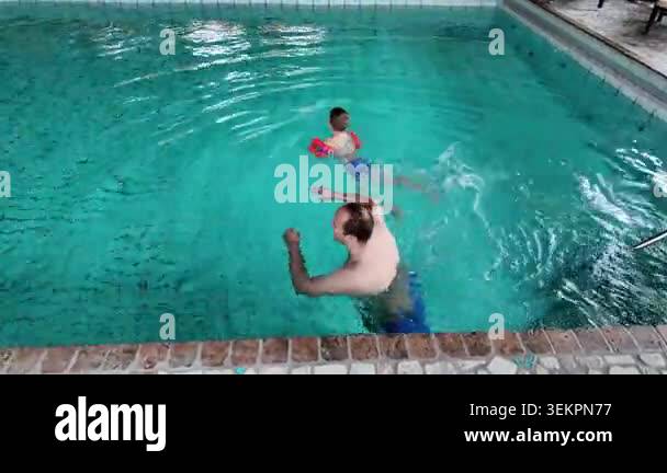 Top view of a cheerful father playing with his children in a bright ...