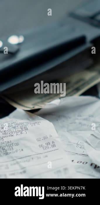 Close-up of invoices and receipts for goods from a store. Inflation and ...