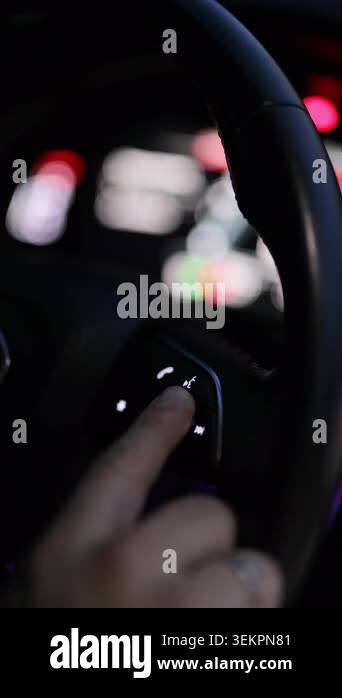 Vertical format video of steering wheel of car control music. The hand ...