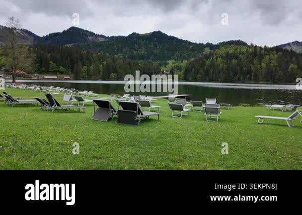 Relax zone with lounge chairs in mountain resort. Row of empty lounge ...