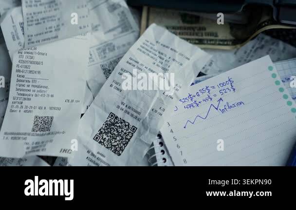 Close-up of invoices and receipts for goods from a store. Inflation and ...