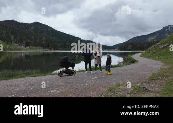 The family group with a modern black stroller is positioned in the ...