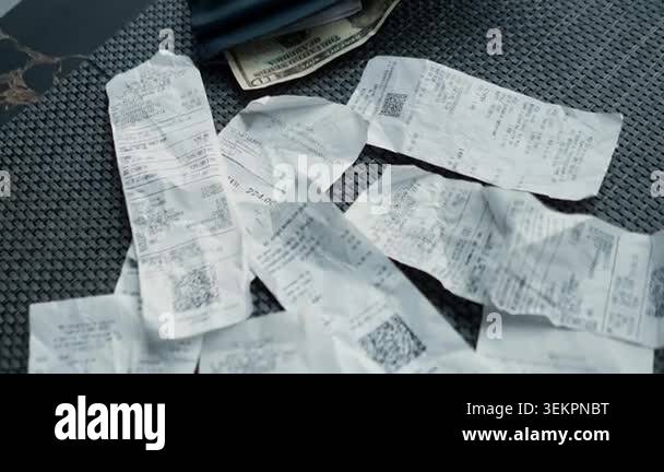 Close-up of invoices and receipts for goods from a store. Inflation and ...