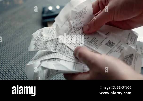 Close-up of invoices and receipts for goods from a store. Inflation and ...