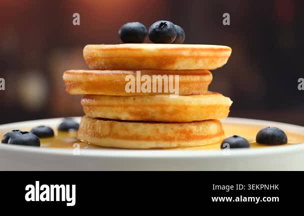 Pancakes stack with dripping honey syrup and blueberries, macro, sweet ...