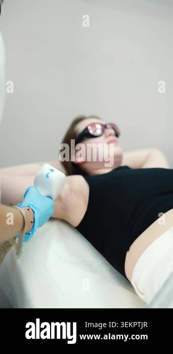 Beauty master makes laser hair removal epilation of armpits close-up in ...