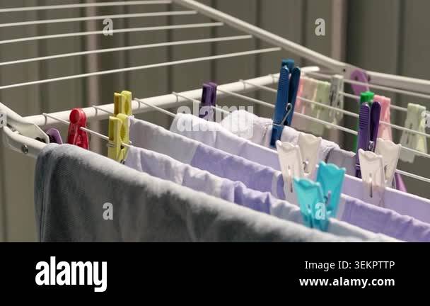 Clothes and linens are dried on a clothesline with clothespins on the ...