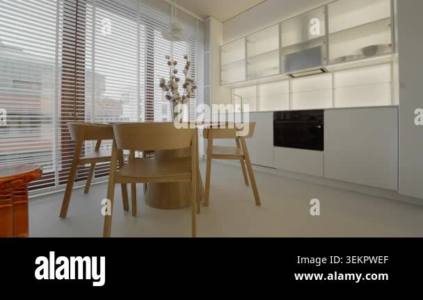 Round wooden dining table with chairs stands inside a brand new ...