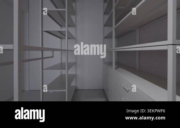 An empty walk-in closet shelving system turns on bright back wall ...