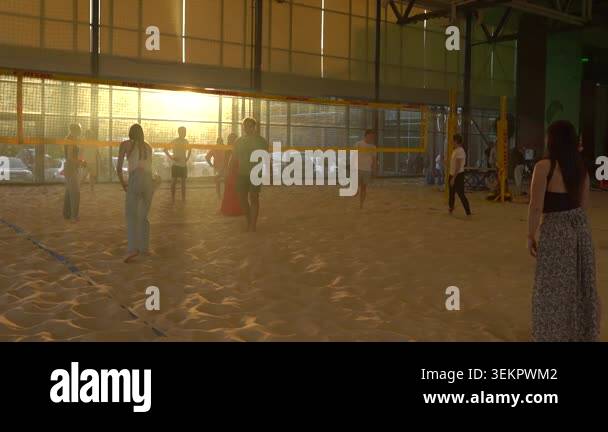 Riga, Latvia - May 27, 2026: Young adults engaged in a beach volleyball ...