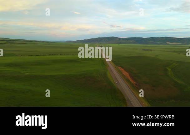 Aerial drone footage captures lone straight highway cutting through ...