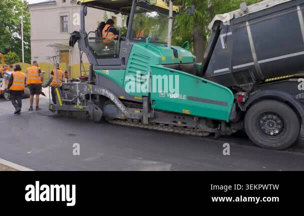 Valmiera, Latvia - May 28, 2026: Construction team uses Vogele asphalt ...