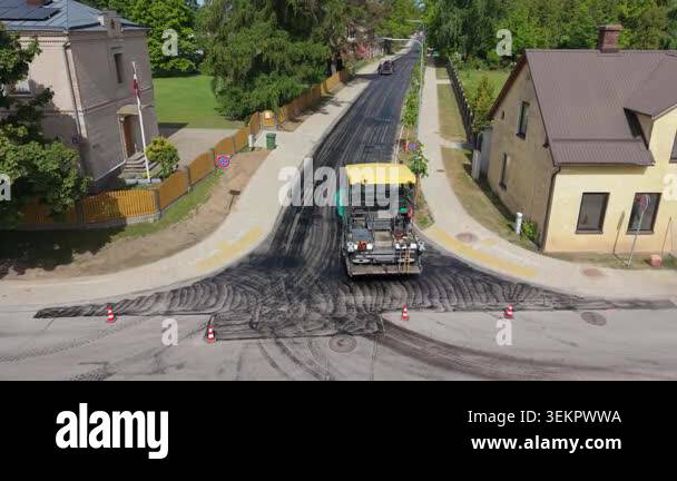 Valmiera, Latvia - May 28, 2026: Road construction vehicle spreads ...