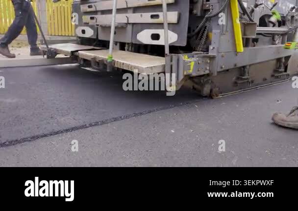 Valmiera, Latvia - May 28, 2026: Asphalt paving machine applies new ...