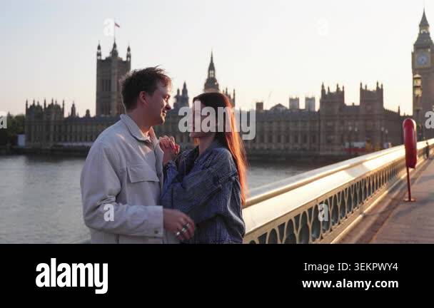Love couple sharing romantic moment on Westminster Bridge in London ...