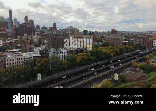 Drone view over Brooklyn residential neighborhood with highway traffic ...