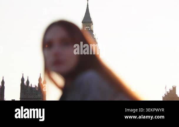 Silhouette of woman with long flowing hair softly blurred in foreground ...