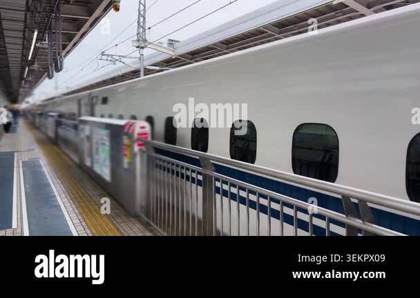 A modern Japanese Shinkansen bullet train stops at Shin-Osaka station ...