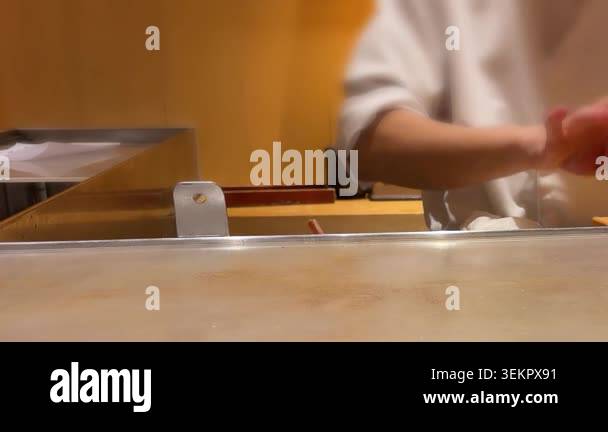 Professional sushi chef preparing fresh tuna fillet at traditional ...