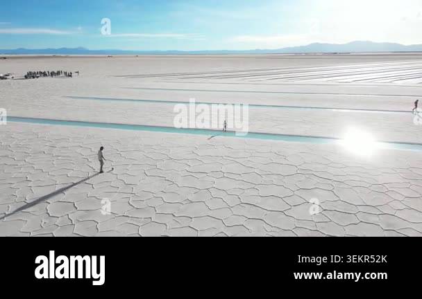 Aerial view of Man and child playing soccer beside turquoise saltwater ...