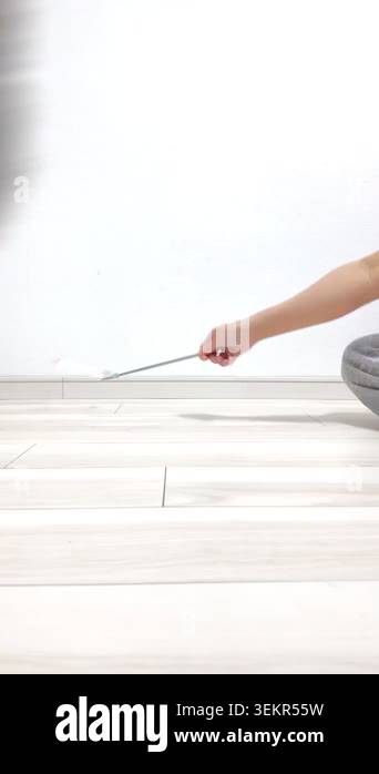 Static low angle shot of a person hand moving a plastic ribbon teaser ...