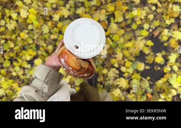 Woman in trench coat keeping in hand big paper coffee cup and fresh ...