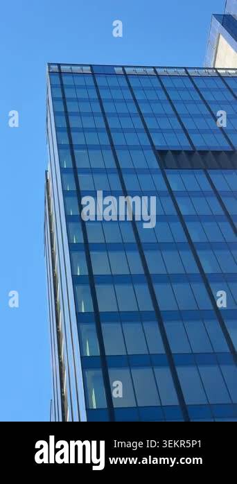Modern skyscraper building exterior facade under clear blue sky low ...