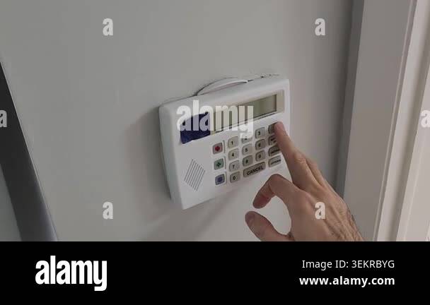 Video footage of a hand pressing buttons on a wall mounted electronic ...