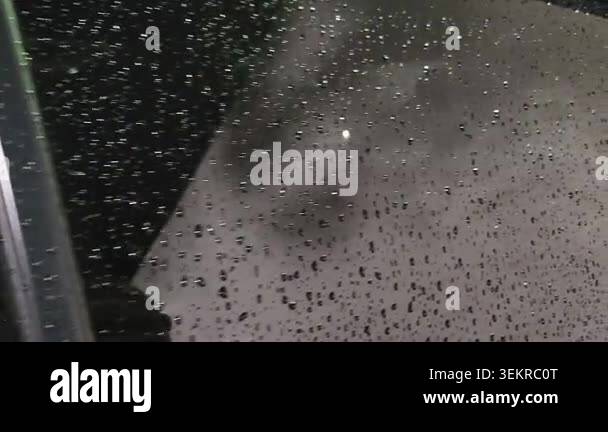 Rain droplets on vehicle window during nighttime Stock Video Footage ...