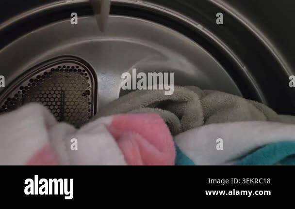 Detailed image of colorful towels and fabric items loaded inside a ...