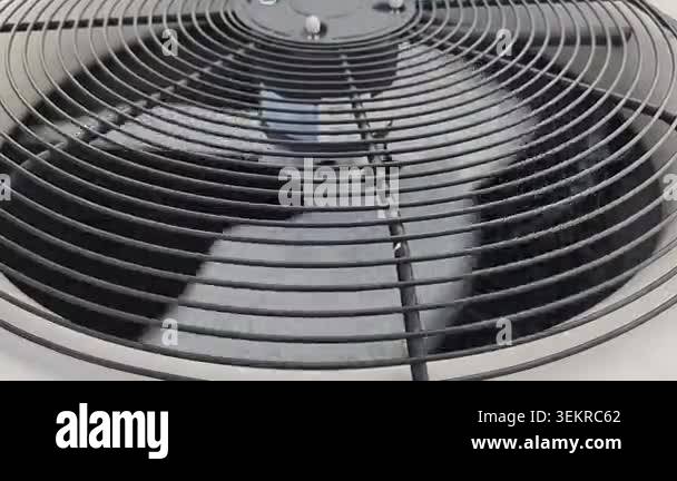 Top view of rotating fan inside outdoor HVAC condenser unit Stock Video ...